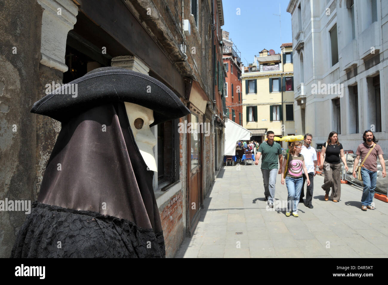 A masked puppet, dressed in a black cloack with matching hat, promotes ...