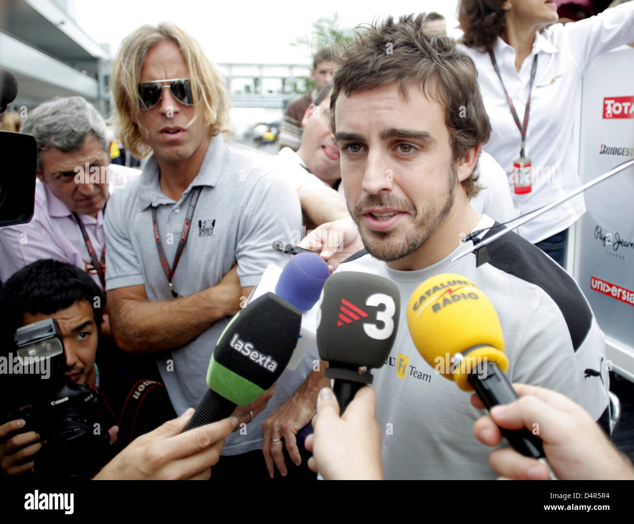 Spanish Formula One driver Fernando Alonso of Renault F1 Team speaks to ...