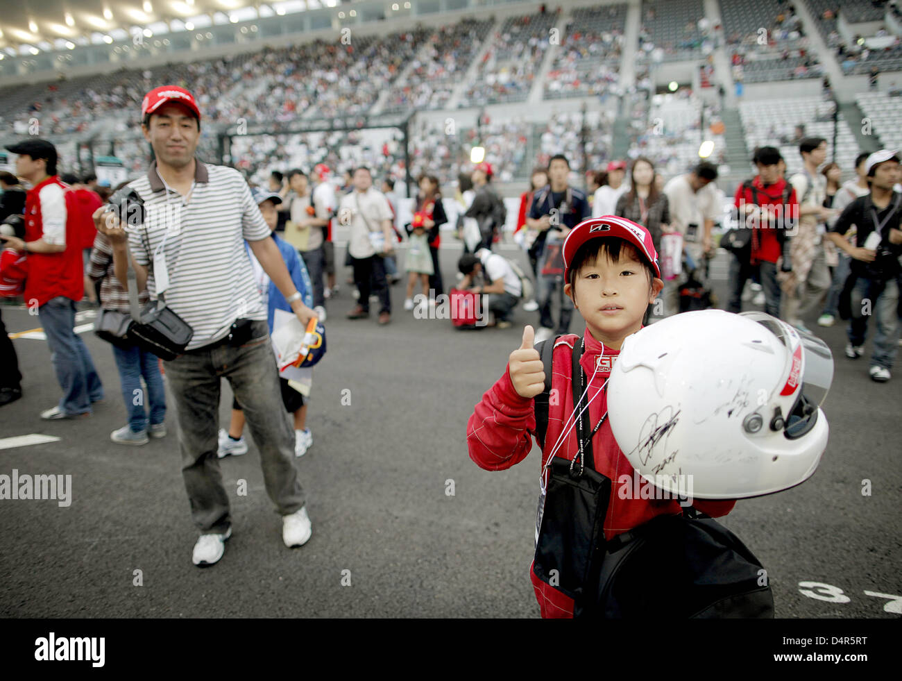 Japanese Formula One fans in the pit lane during an autograph session ...