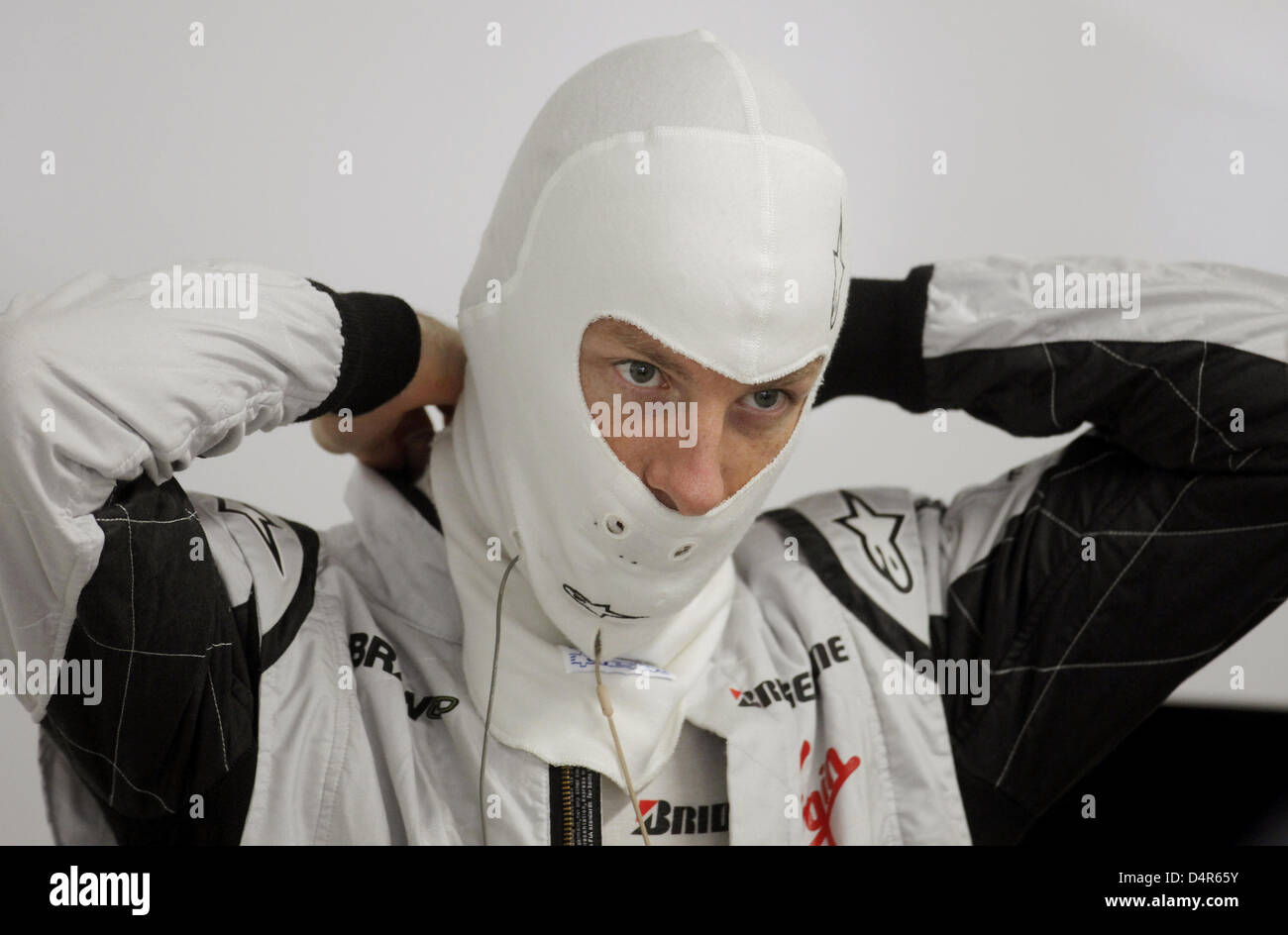 British Formula One driver Jenson Button of Brawn GP adjusts his fire ...