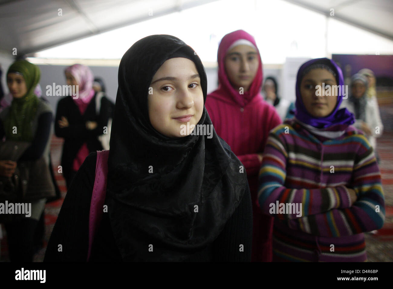Girls listen to an imam in a provisional tent mosque in Cologne ...