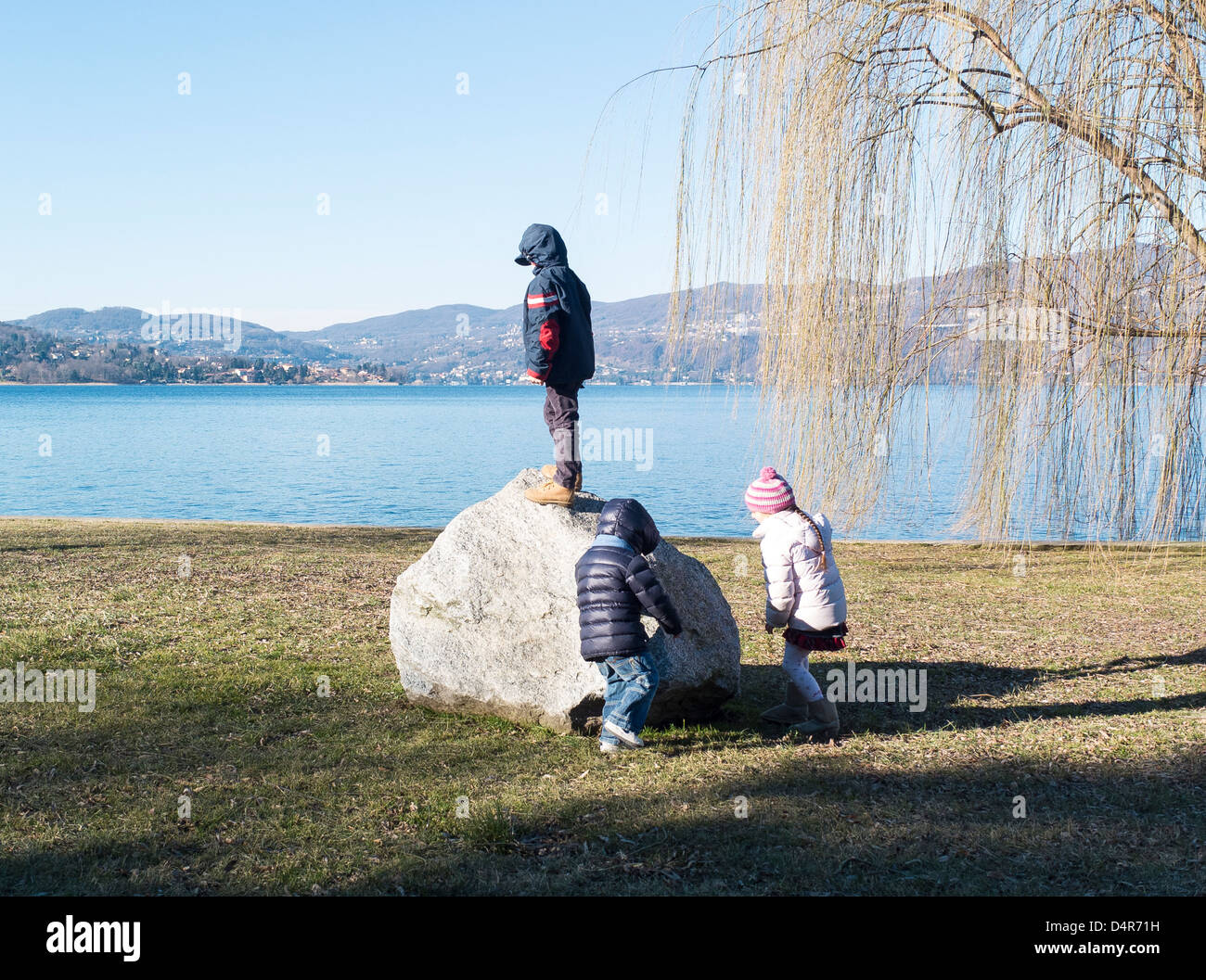 children climb over a boulder Stock Photo - Alamy