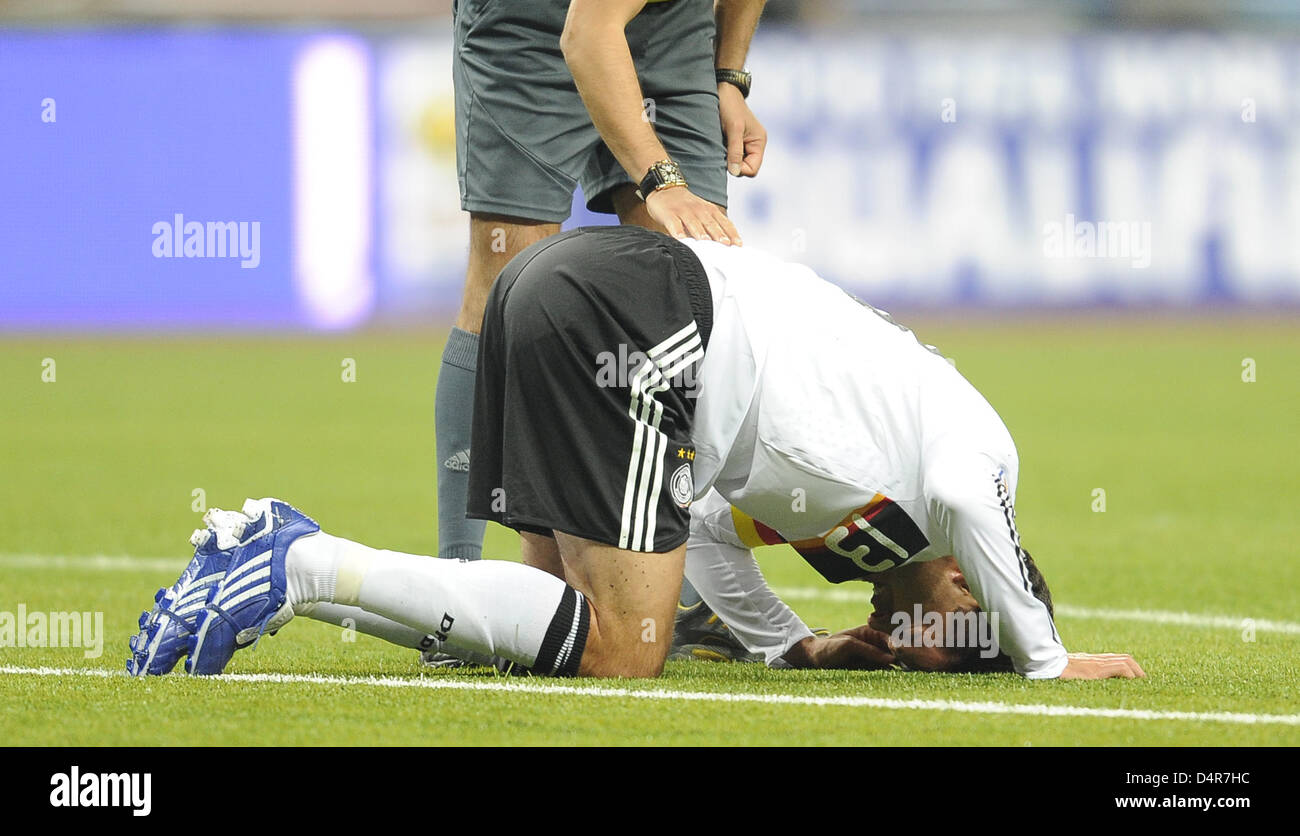 Swiss referee Massimo Busacca takes care of injured German Michael ...