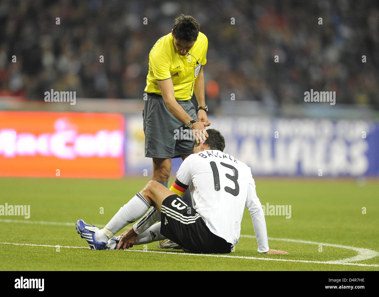 Swiss referee Massimo Busacca takes care of injured German Michael ...