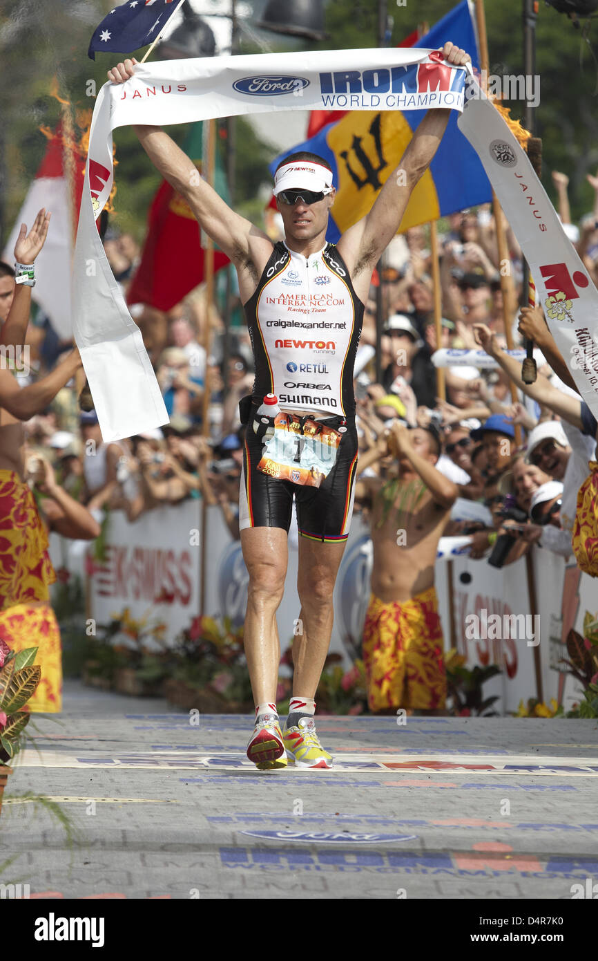 Australian athlete Craig Alexander is the first to cross the finish ...