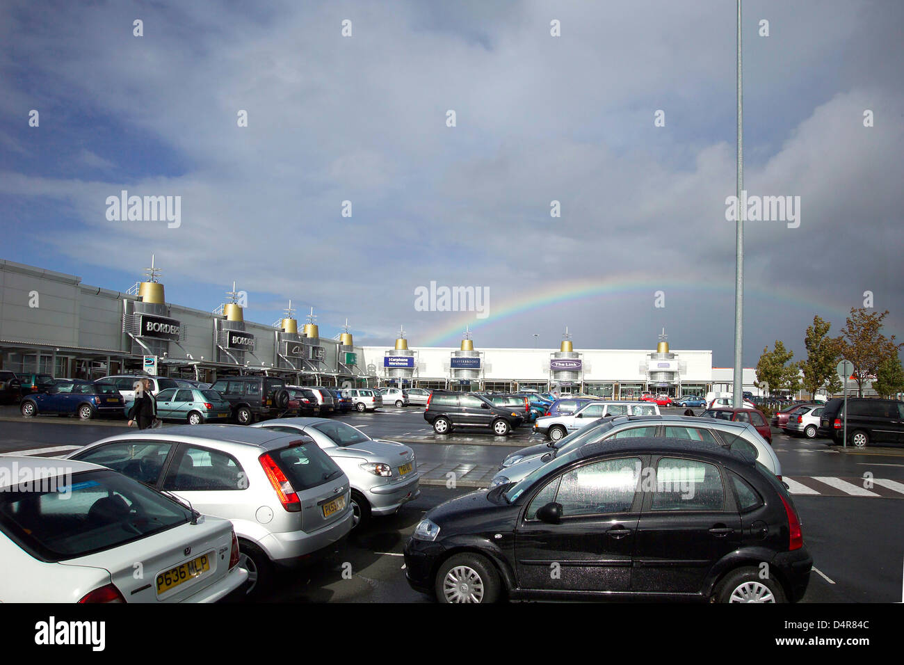 fort kinnaird shopping centre from car park with stormy skies and ...