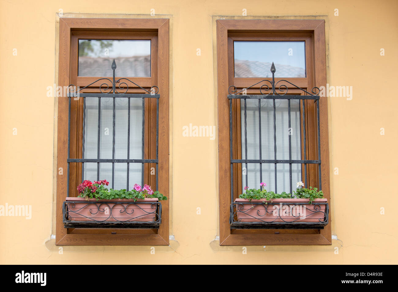 Turkish old fashioned house windows with black bars and geraniums in ...