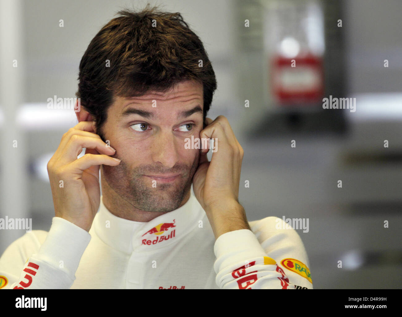 Australian Formula One driver Mark Webber of Red Bull Racing protects ...