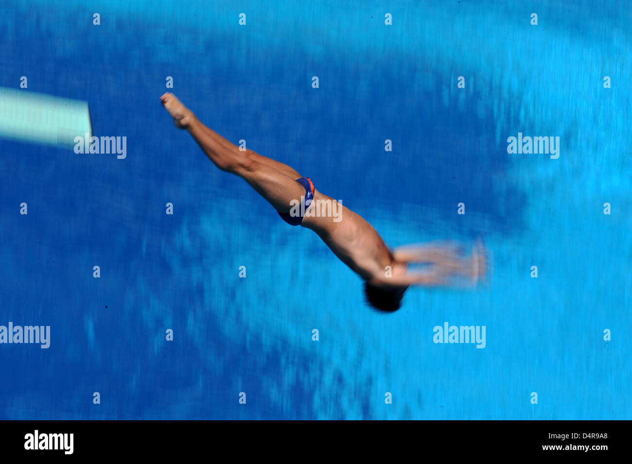 A diver dives into the water during the 3m diving competition at the ...