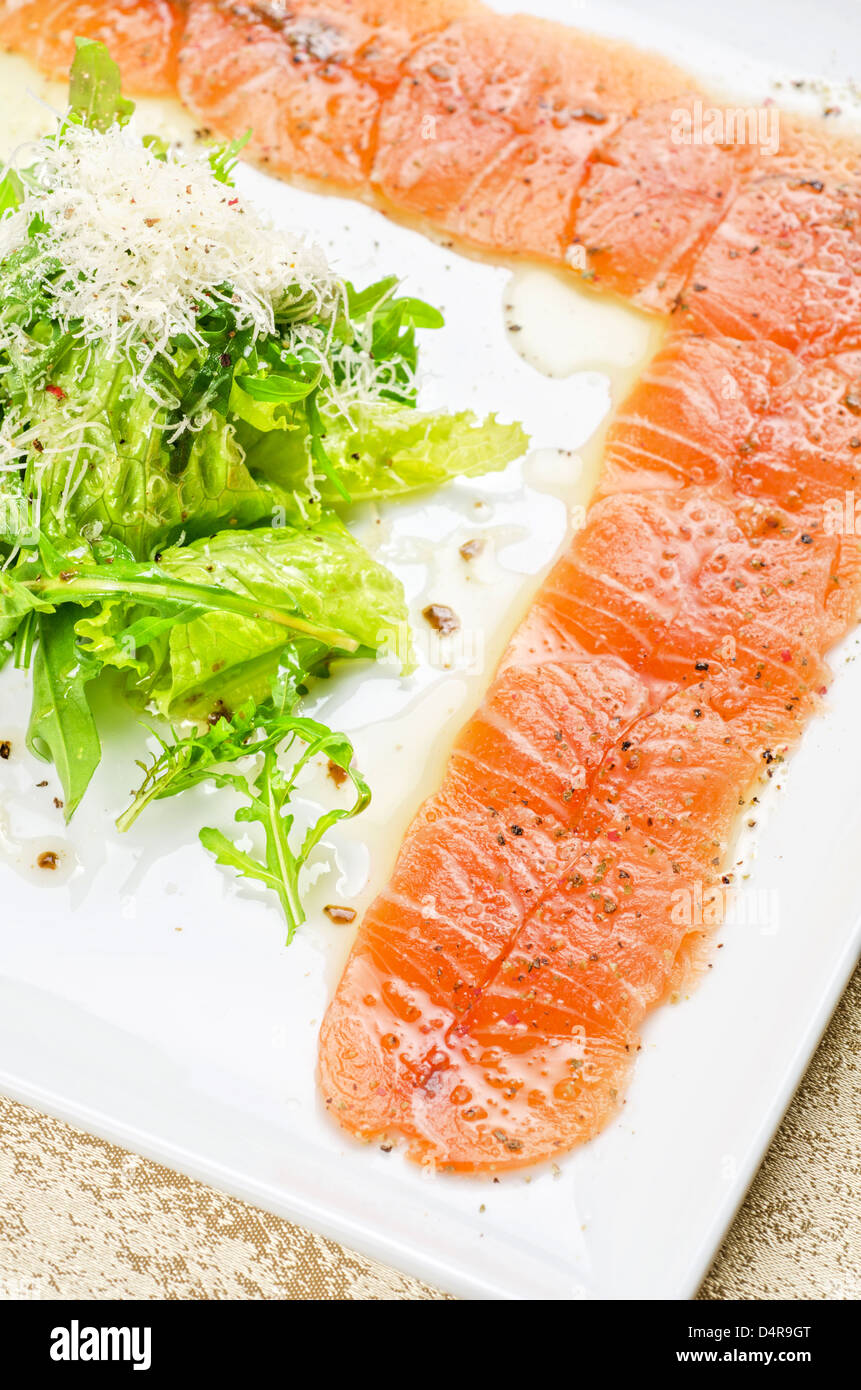 Fish Carpaccio with salad Stock Photo - Alamy