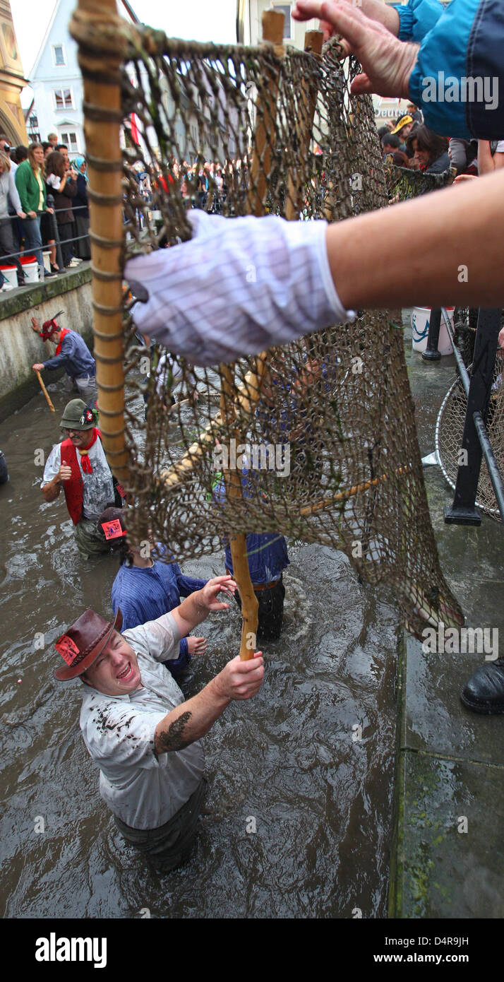 Participants of the Memmingen fishing day fish for trouts with wooden ...