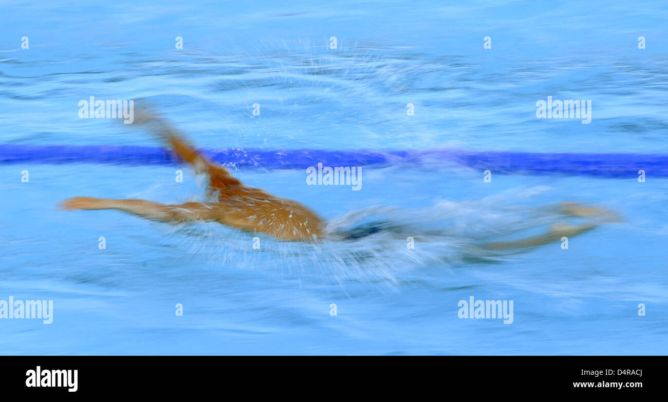 A swimmer competes in a 200m Butterfly prelim heat at the FINA Swimming ...