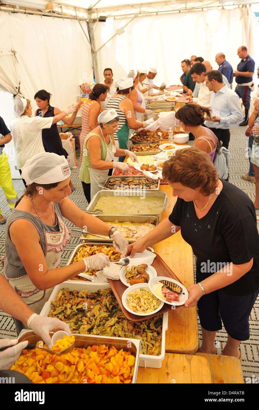 Inhabitants receive their lunch in a canteen tent in Onna, Italy, 29 ...