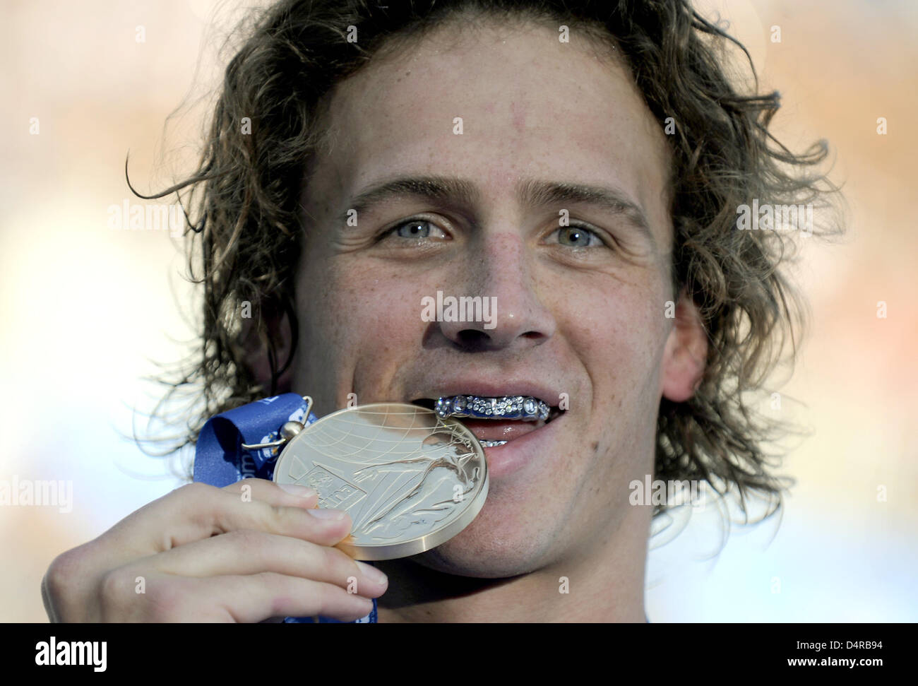 US swimmer Ryan Lochte shows his gold medal after the final in the men ...