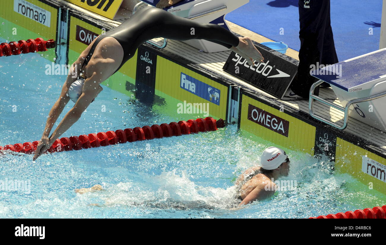 German swimmer Felix Wolf jumps into the pool as Paul Biedermann (R ...