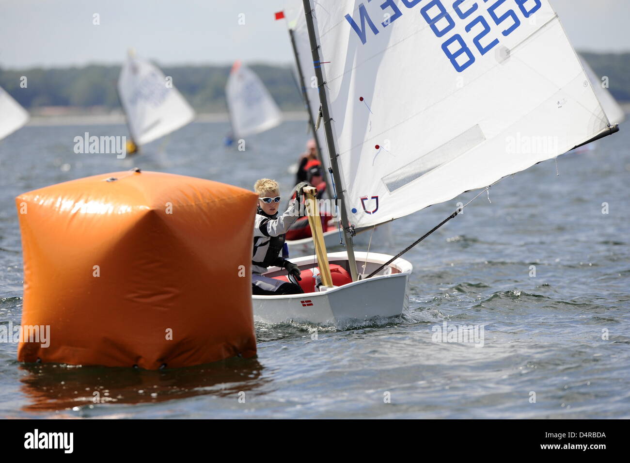 Sailing boats of the optimist class are pictured during a regatta at ...