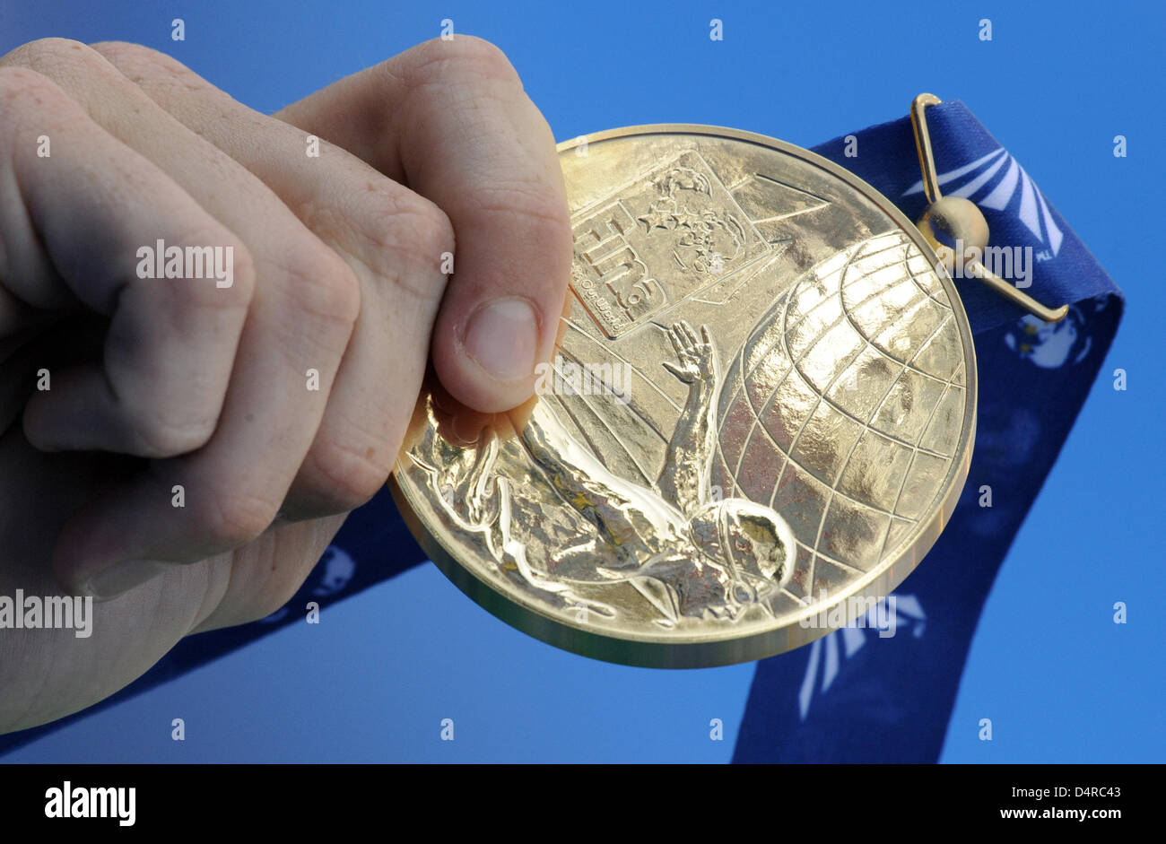 Chinese swimmer Lin Zhang poses with his gold medal on the podium of ...