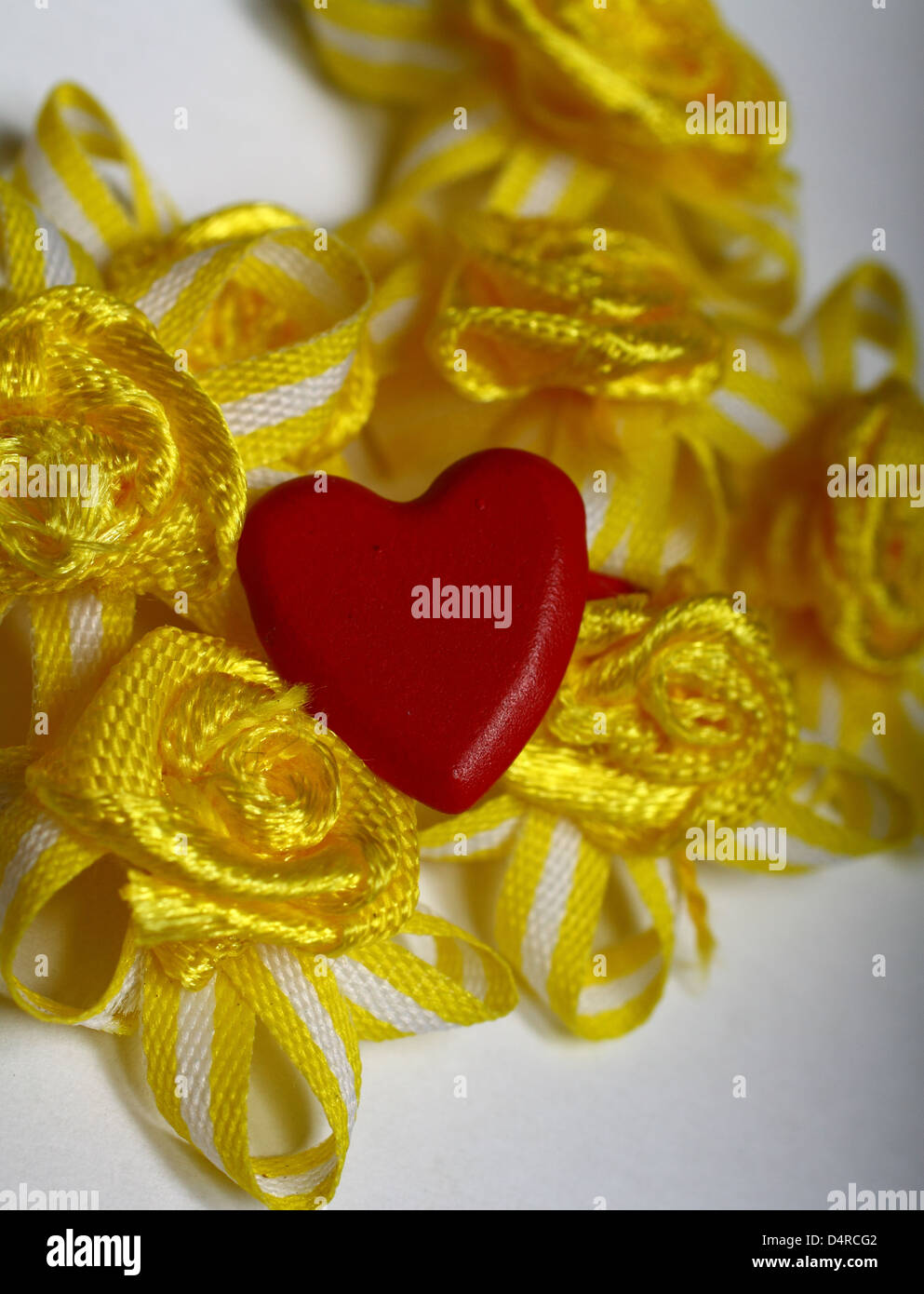 Heart on ribbon flower embellishments Stock Photo - Alamy