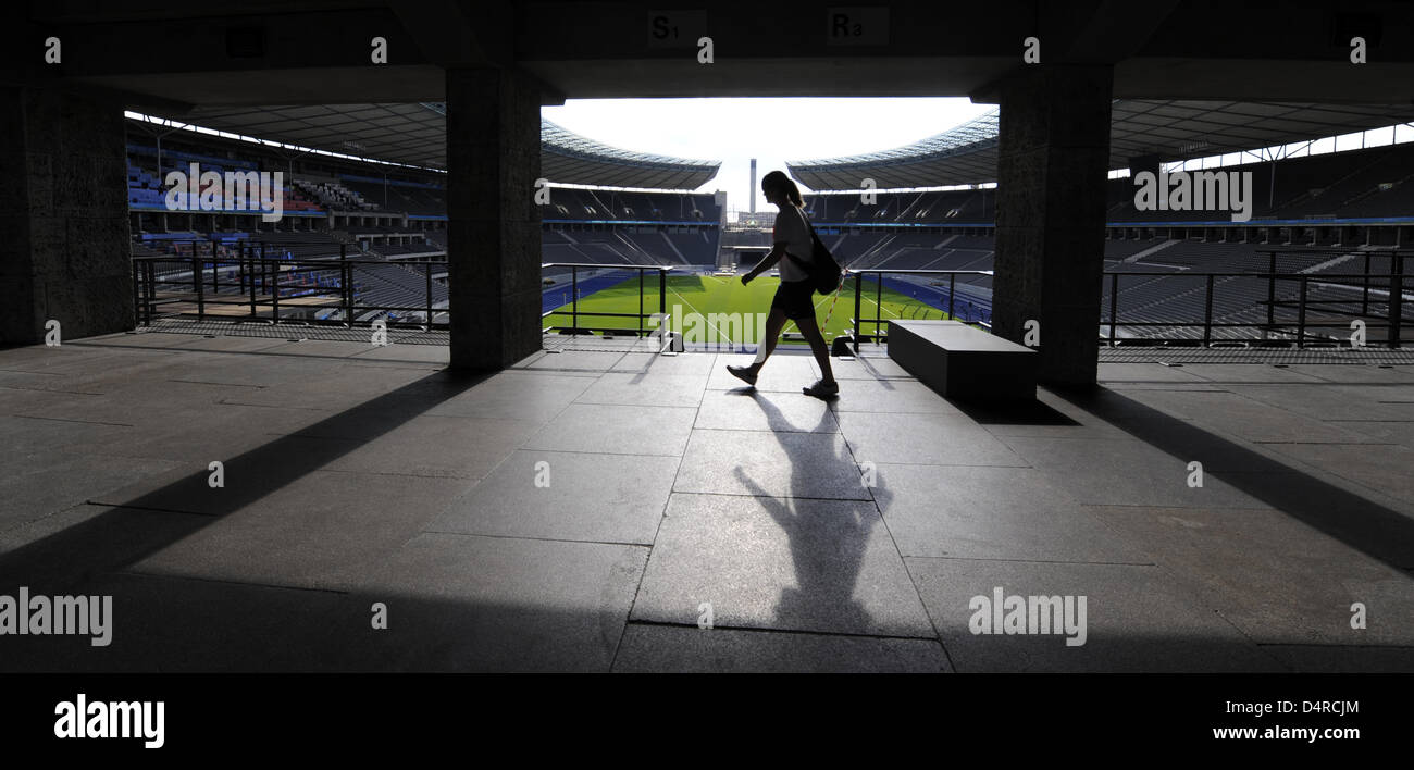 A so-called ?Volunteer? walks through the visitor?s area at the Olympic ...