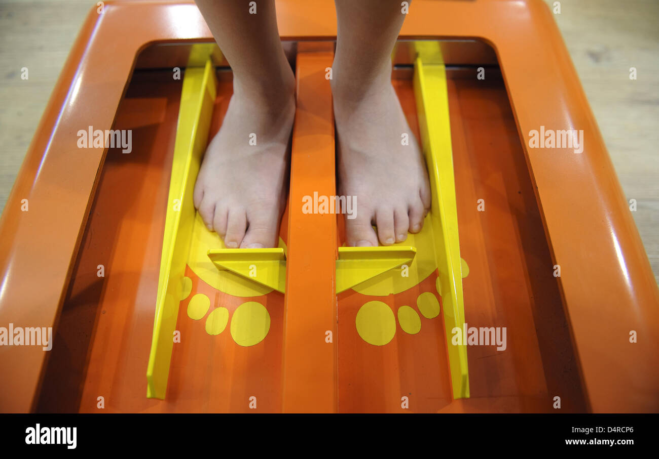 The Size Of A Child s Feet Is Measured With A Special Device In A Shoe the-size-of-a-child-s-feet-is-measured-with-a-special-device-in-a-shoe