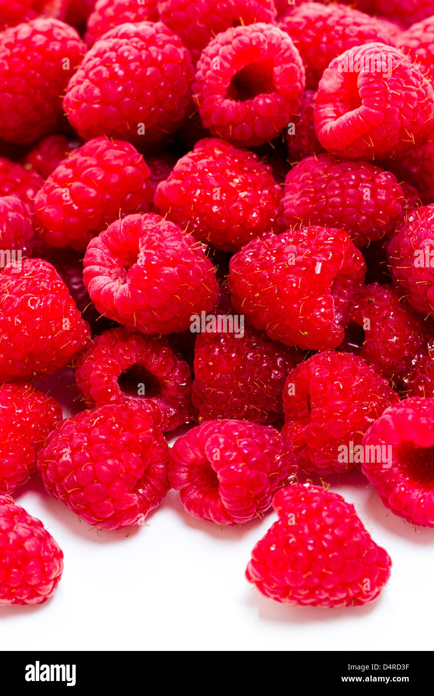 Heap of organic raspberries on white background Stock Photo - Alamy