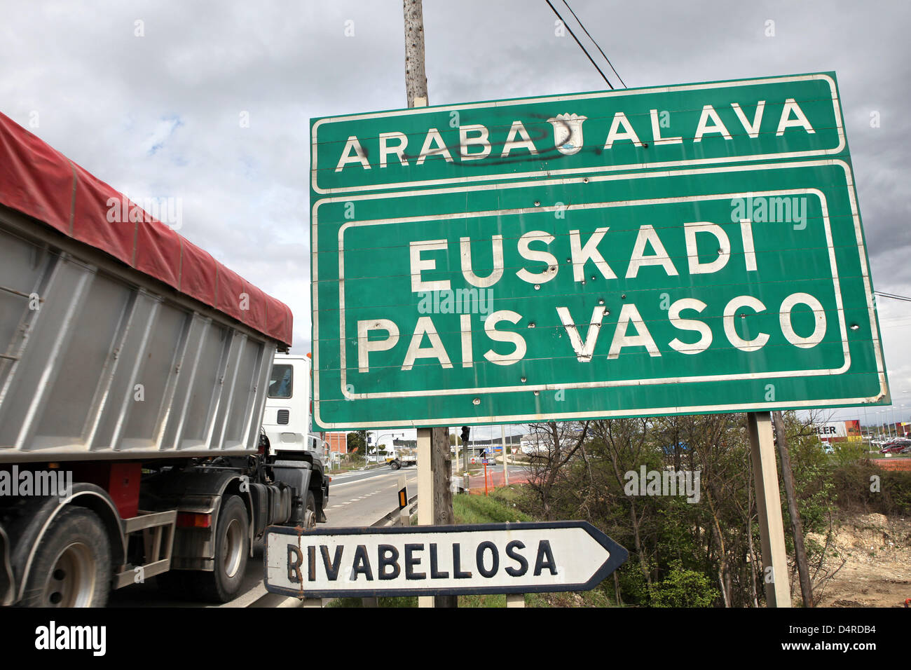 A road sign strewn with bullet holes near Rivabellos Spanish province ...