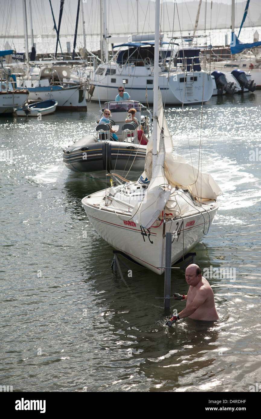 Man launching yacht on a submerged trailer Knysna waterfront South ...