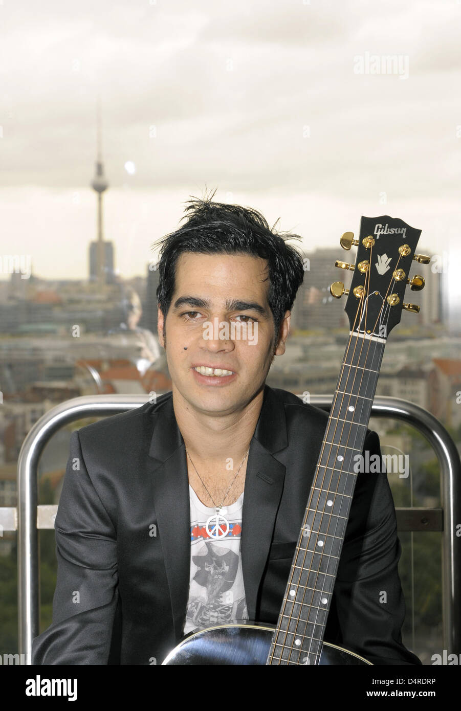 Israeli singer Aviv Geffen poses with his guitar after a press ...