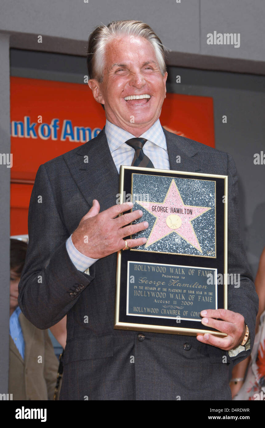 US actor George Hamilton shows his star during the ceremony for his new ...