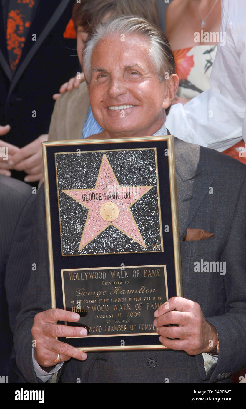 US actor George Hamilton shows his star during the ceremony for his new ...