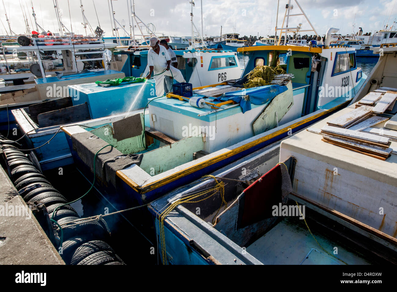 trawlers and fishing boats line the quay at Bridgetown fish market ...
