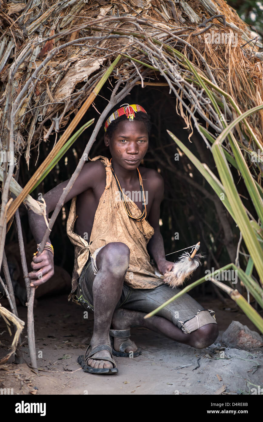 Hadzabe hunter in his hut Stock Photo - Alamy