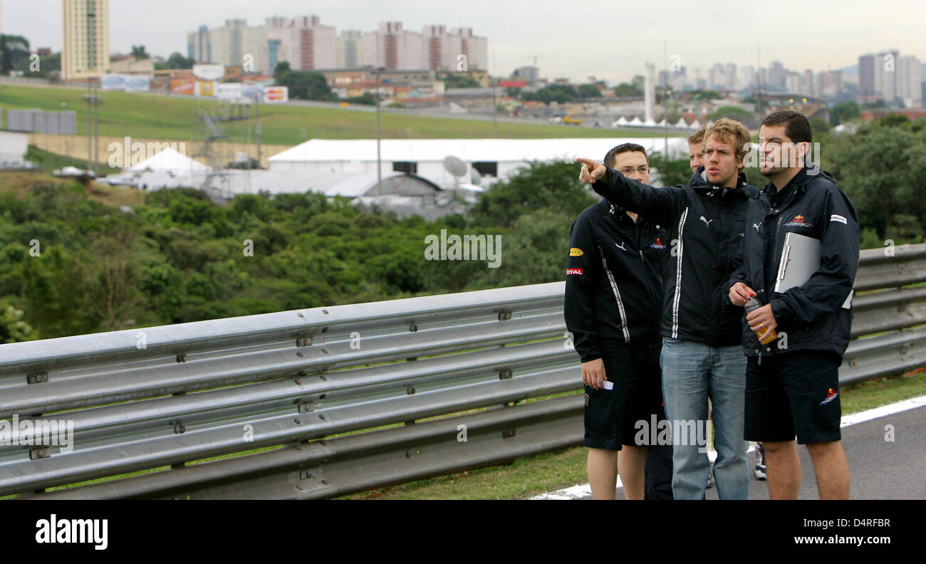 German Formula One driver Sebastian Vettel of Red Bull Racing (C) and ...