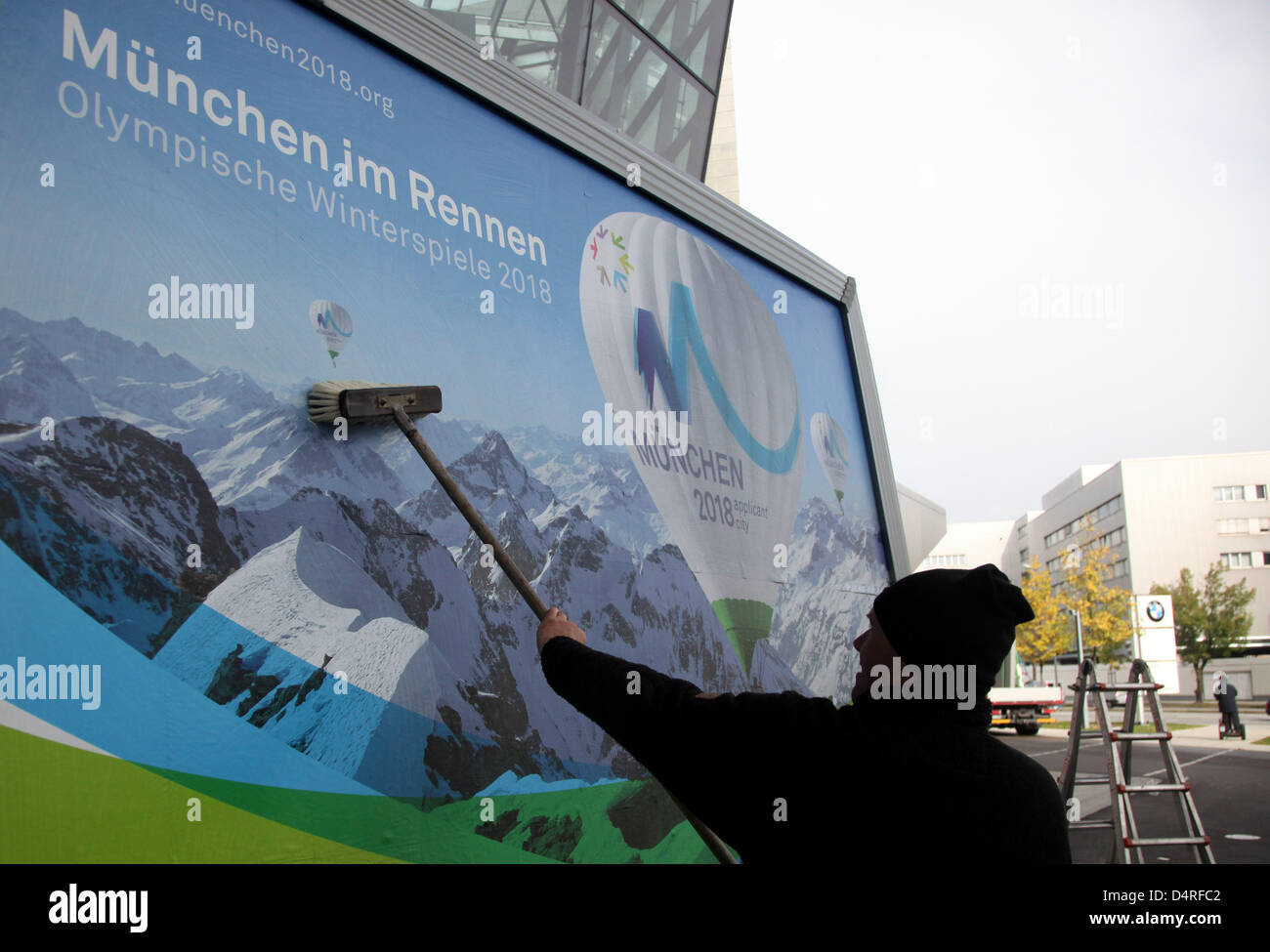 Two men post a banner during the presentatio of the logo for Munich as ...