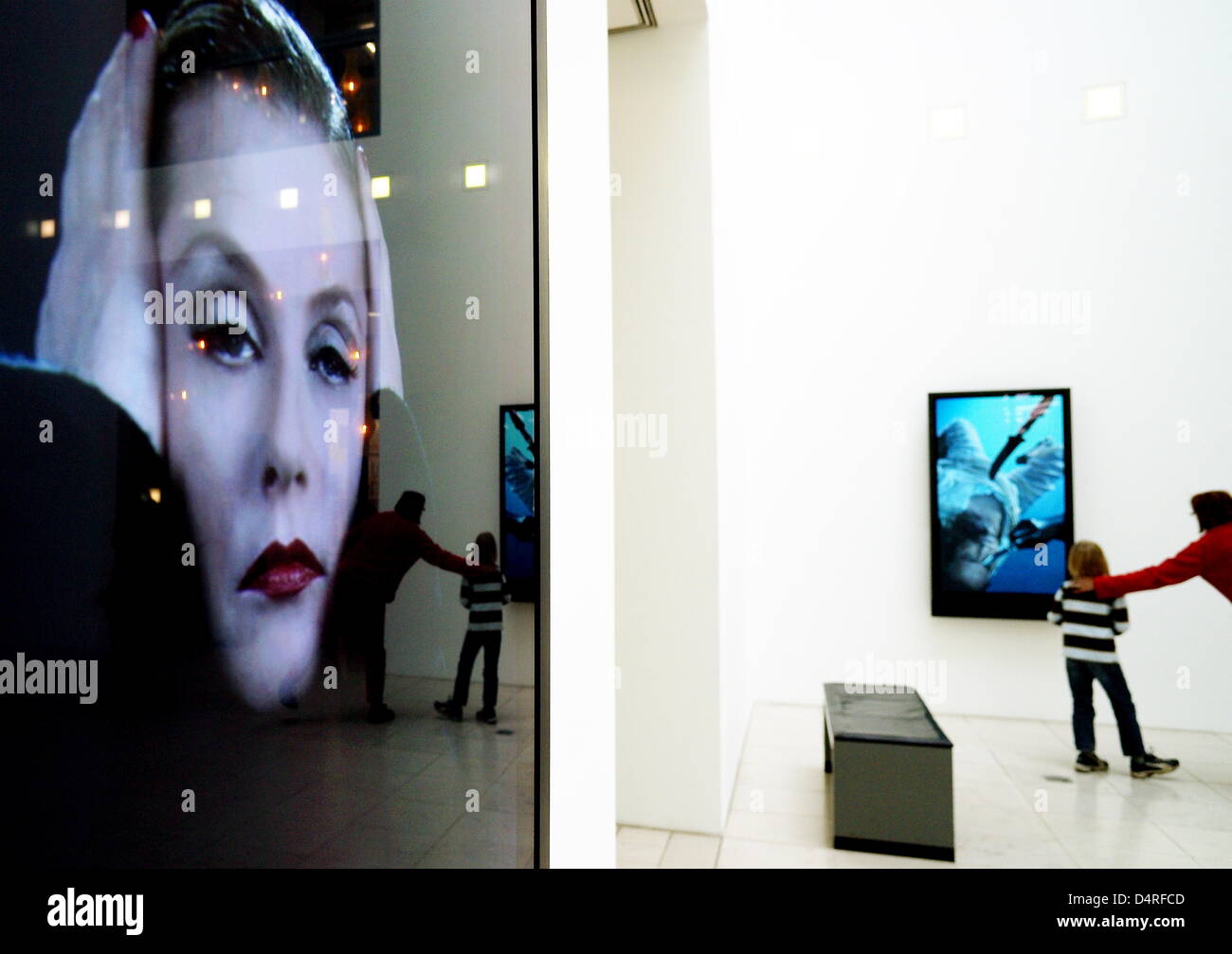 A visitor to the exhibition ?Robert Wilson Video Portraits? eyes the ...