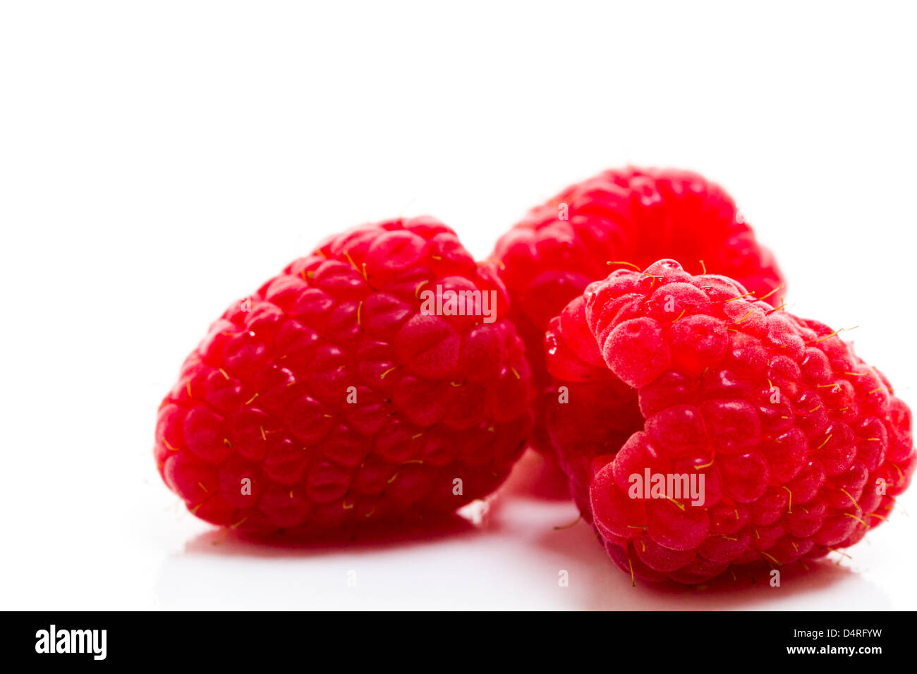 Heap of organic raspberries on white background Stock Photo - Alamy