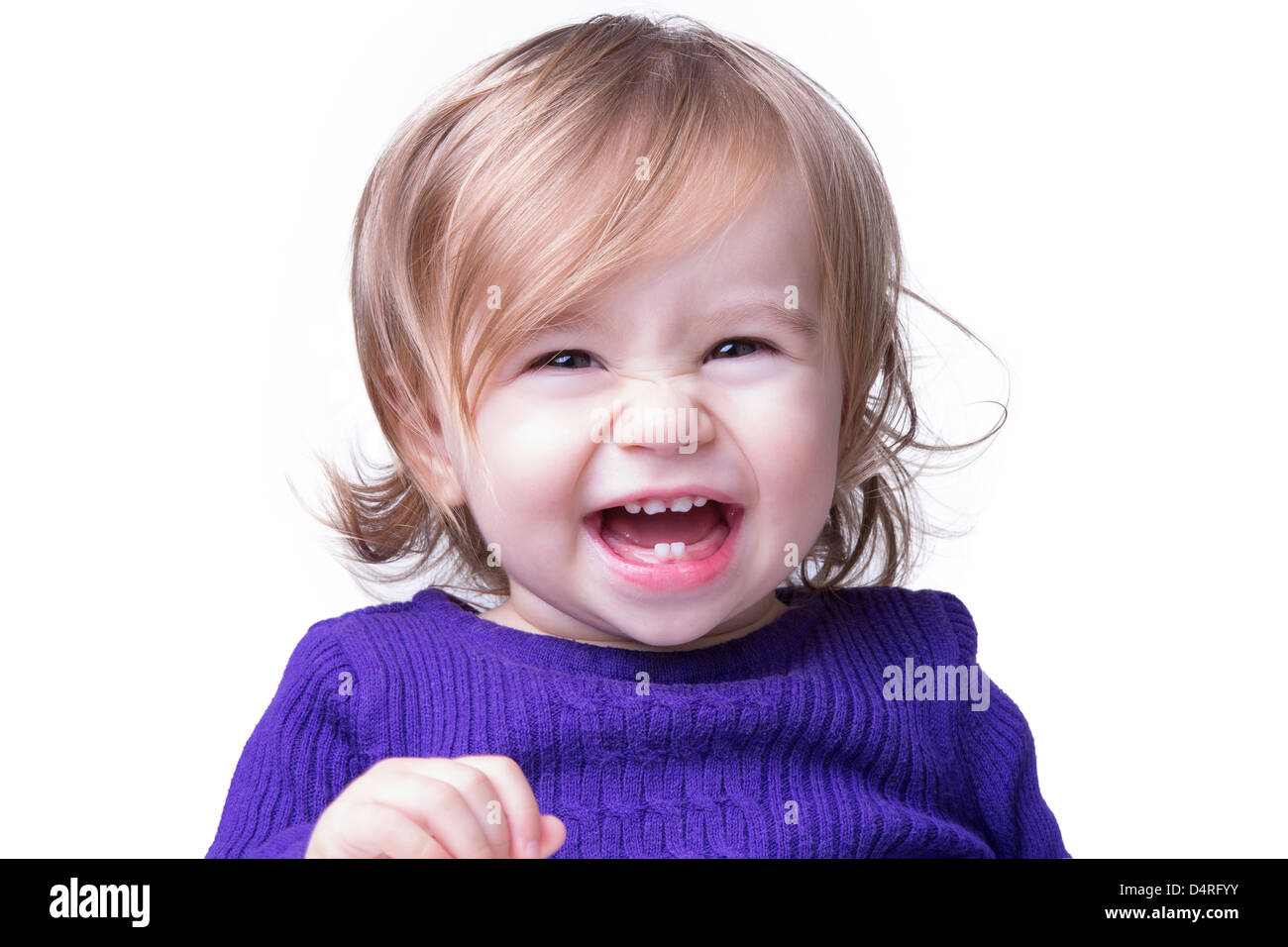 Happy baby is laughing fearless and freely with her new teeth, looking ...