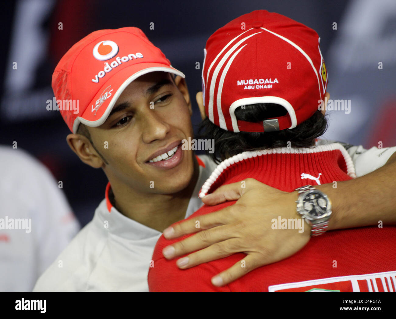 British Formula One driver Lewis Hamilton (L) of McLaren Mercedes hugs ...
