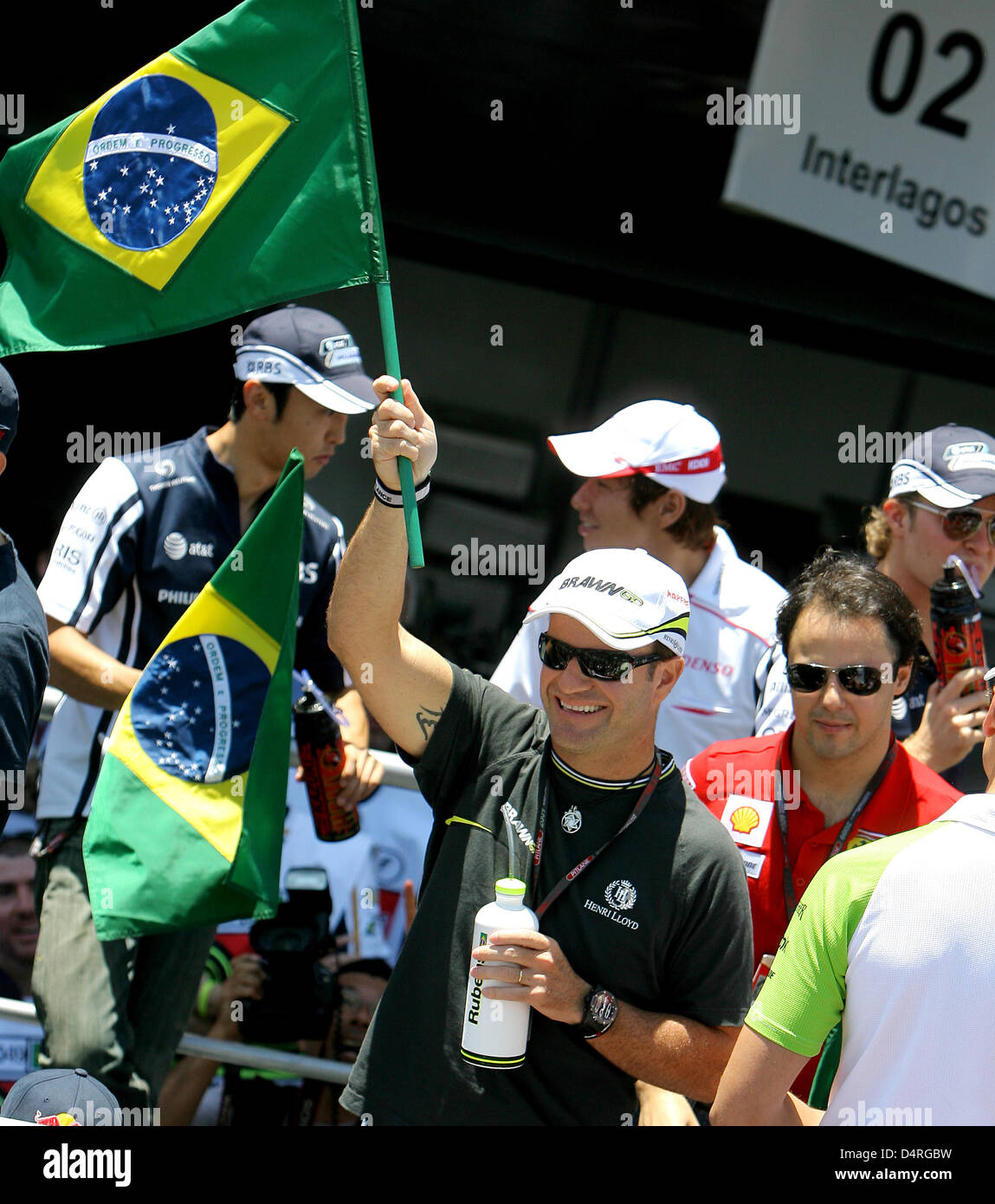 Brazilian Formula One driver Rubens Barrichello (C) of Brawn GP waves a ...