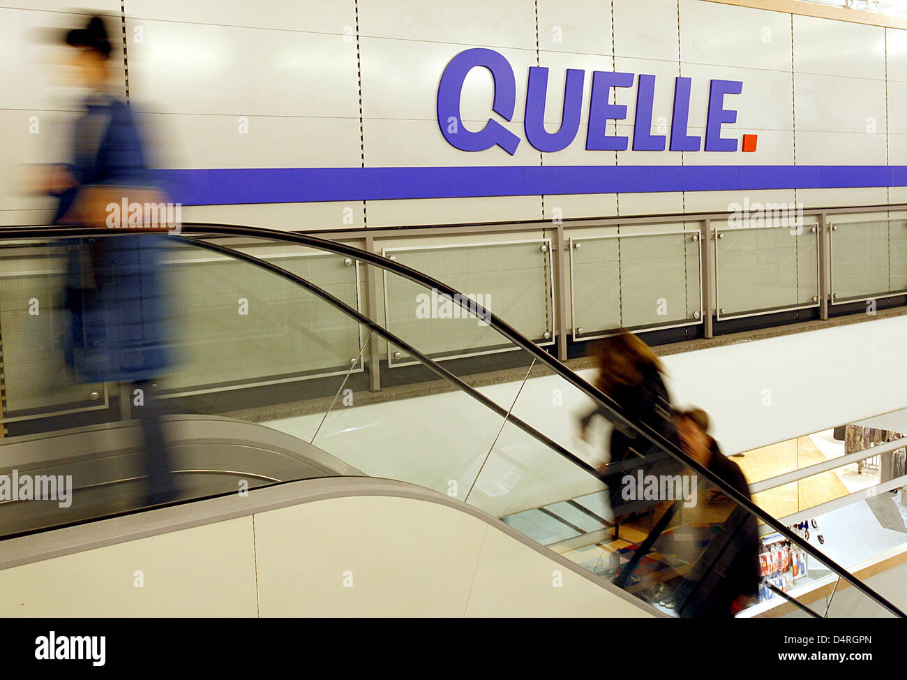 Customers on escalators at the Quelle department store in Nuremberg ...