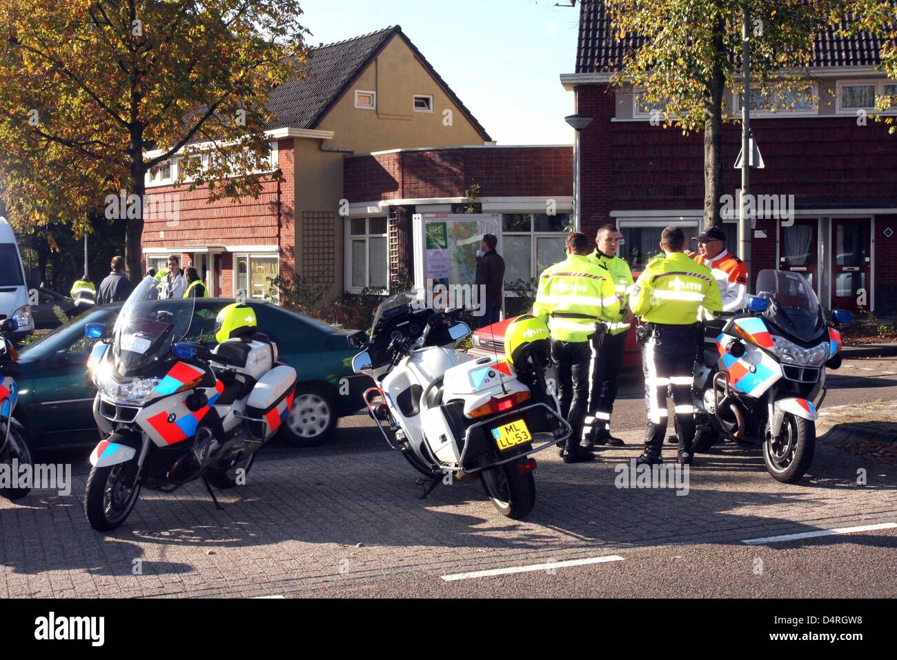 Policemen stand on a street in a residential district in Heerlen ...