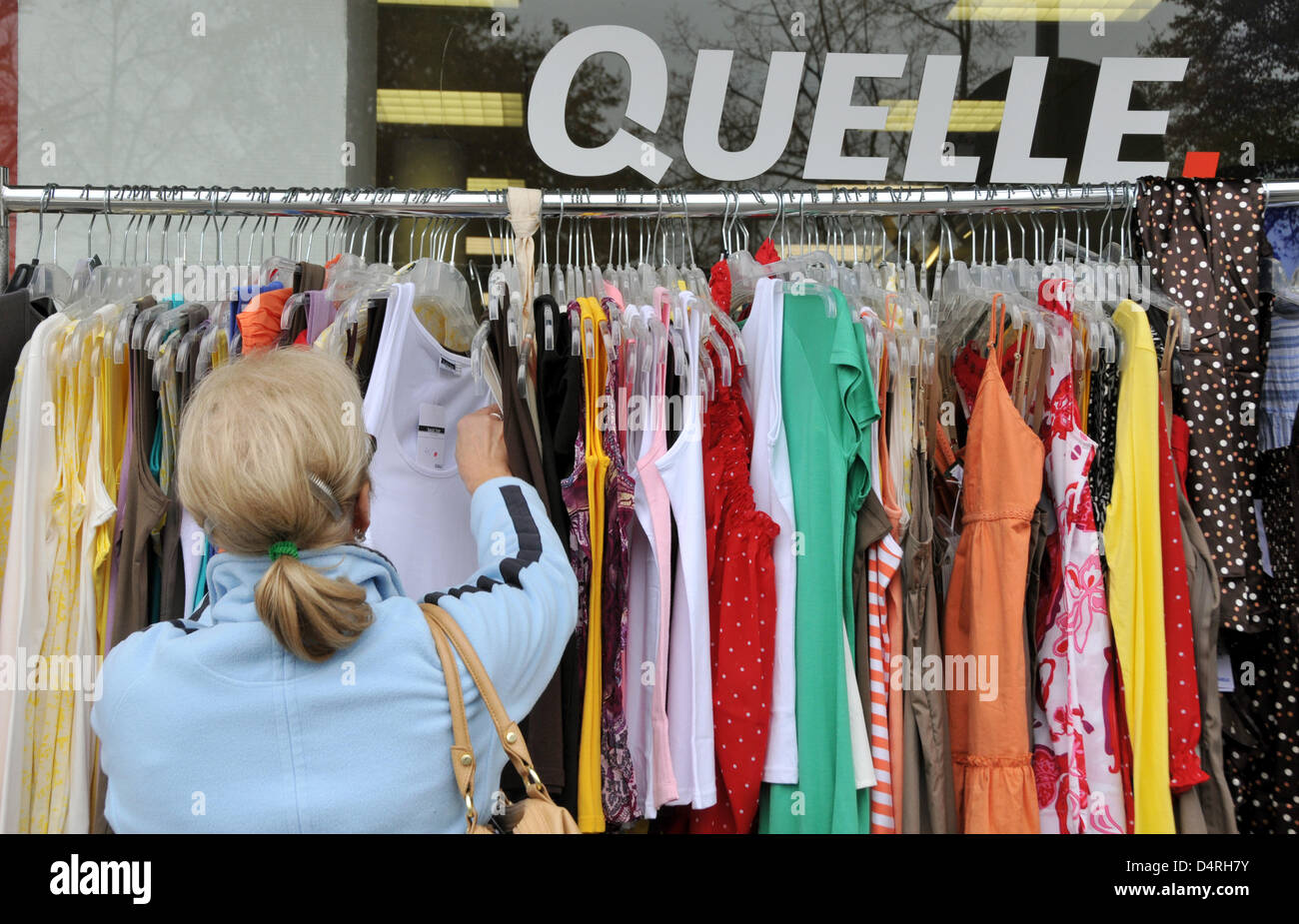 A woman looks for bargain goods in a Quelle department store in Kassel ...