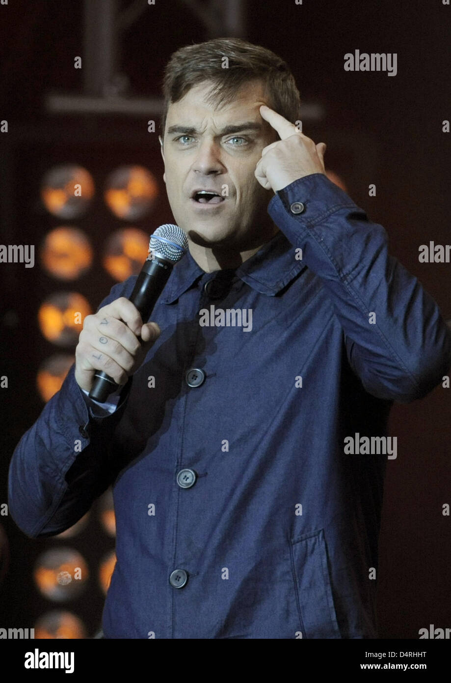 Caption: British singer Robbie Williams performs outside Max Schmeling ...