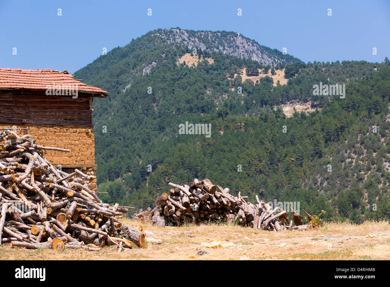 Wood covered adobe barn with woods of winter preparation. Scenic ...