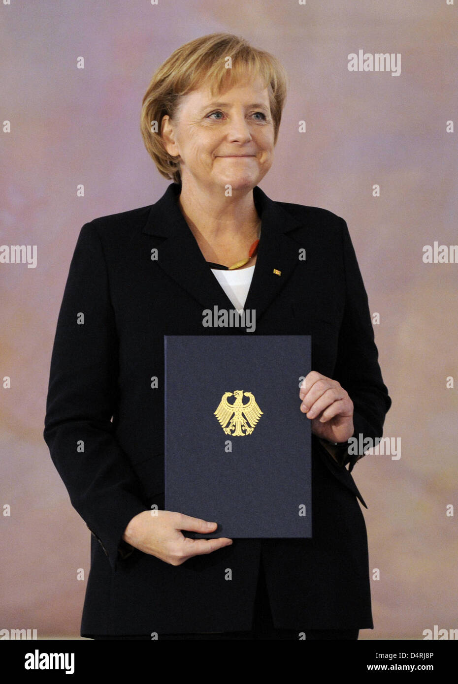 German Chancellor Angela Merkel presents her certificate of appointment ...