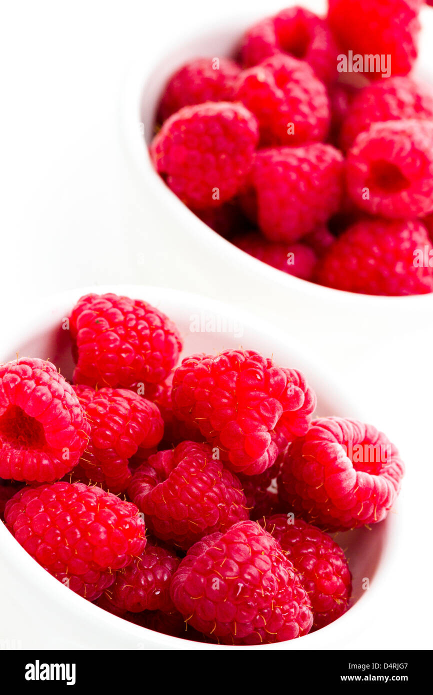Heap of organic raspberries on white background Stock Photo - Alamy