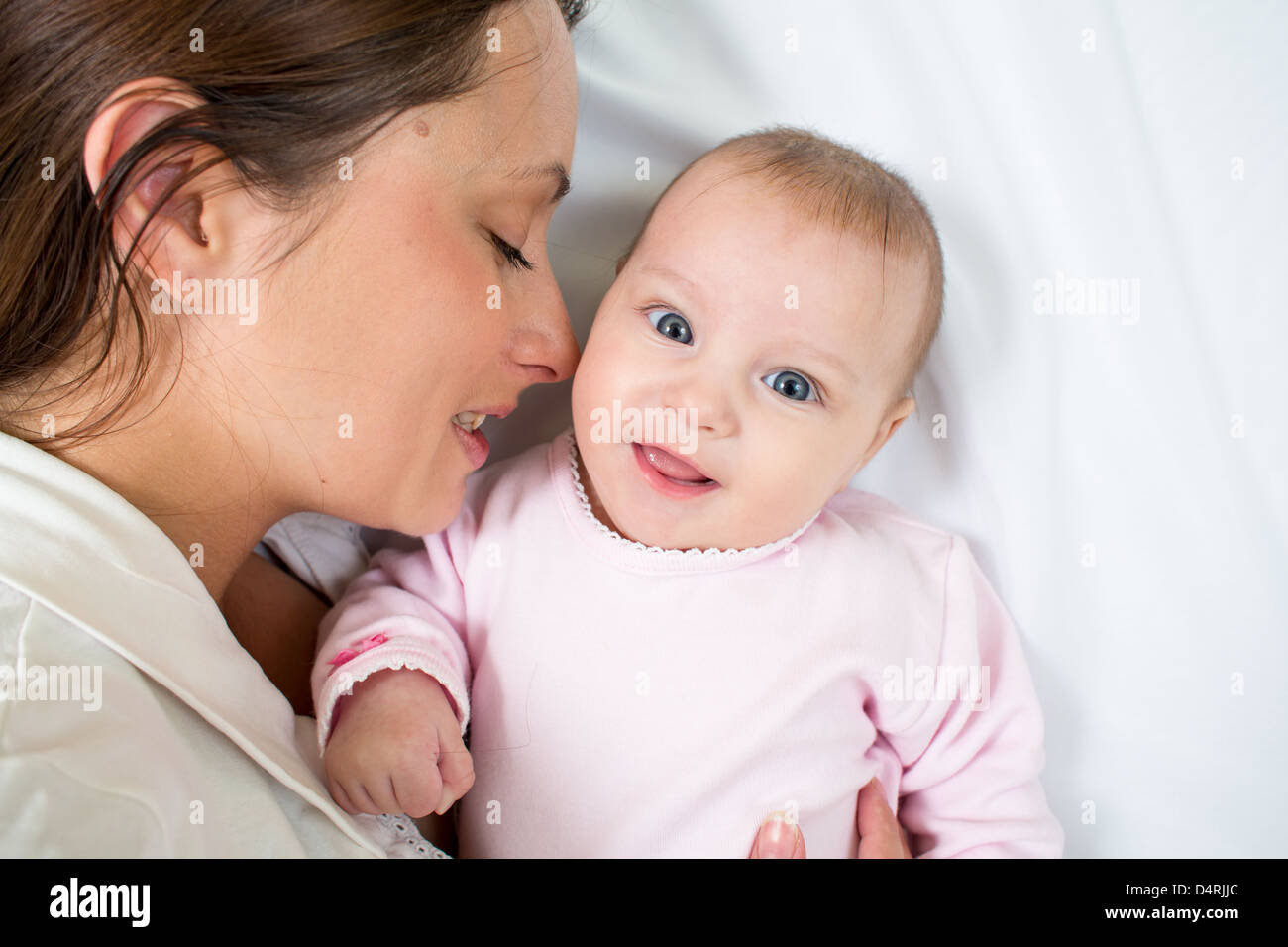 joyful mother watching at her baby girl Stock Photo - Alamy
