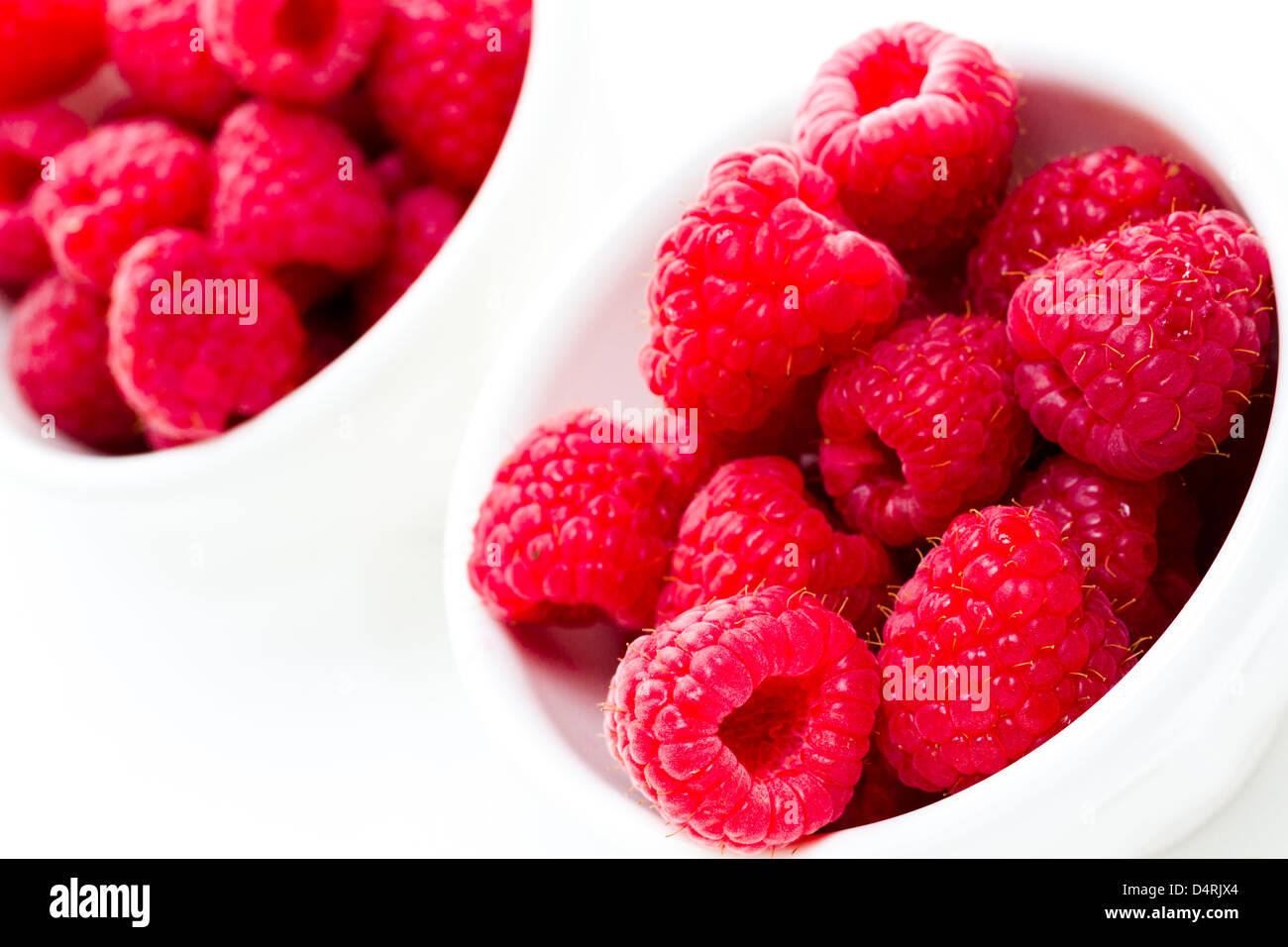 Heap of organic raspberries on white background Stock Photo - Alamy