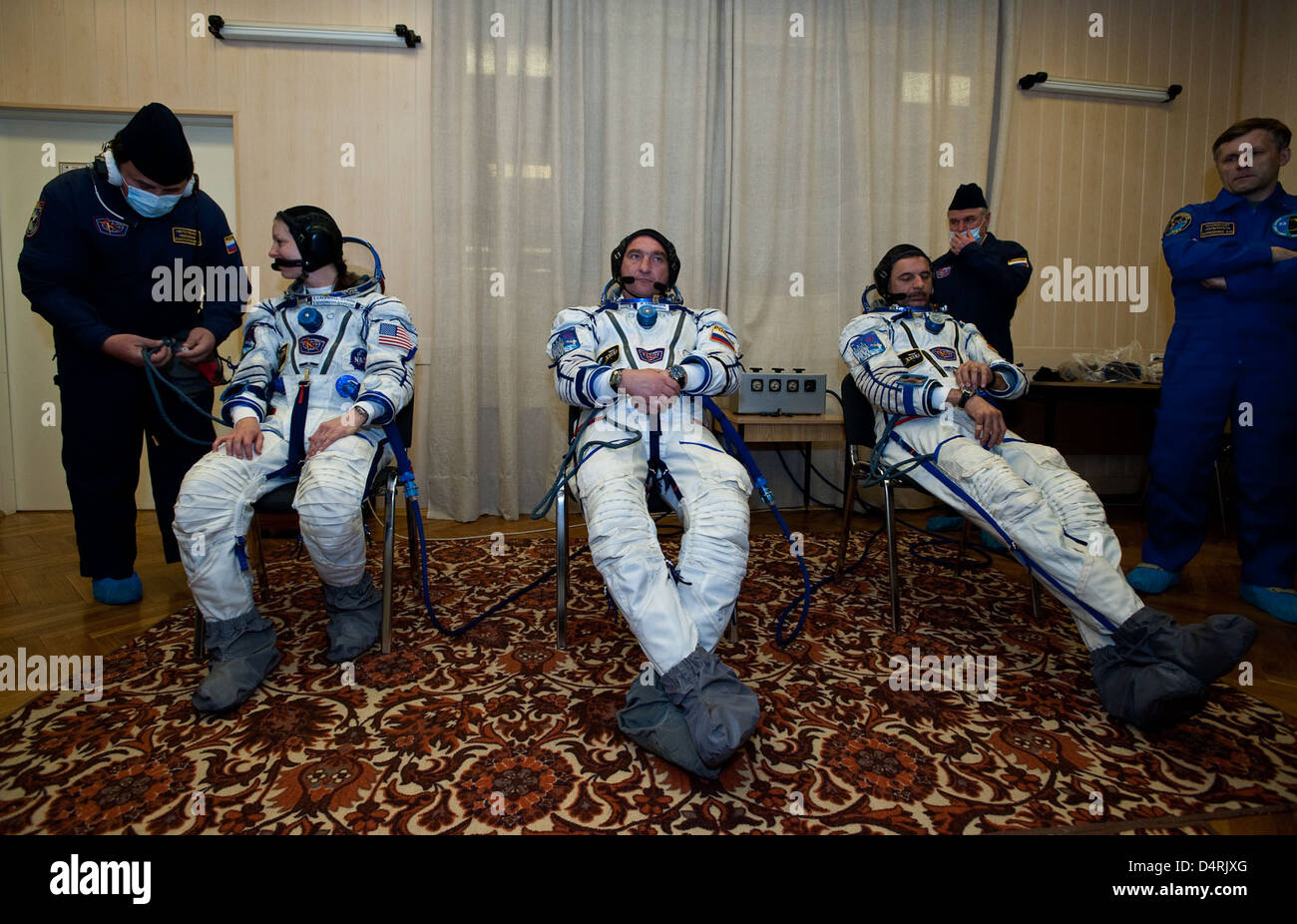 Astronaut Alexander Skvortsov and cosmonauts Mikhail Kornienko prepare ...