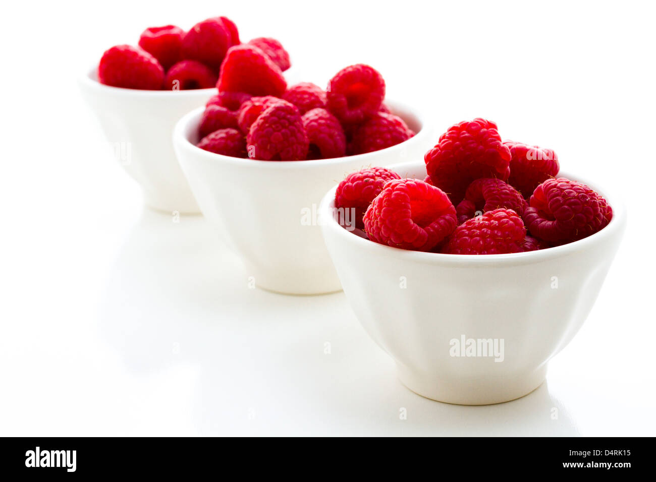 Heap of organic raspberries on white background Stock Photo - Alamy